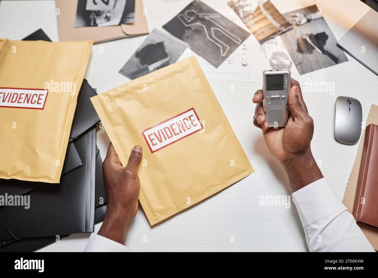 Top view closeup of male detective with hands holding evidence folder ...