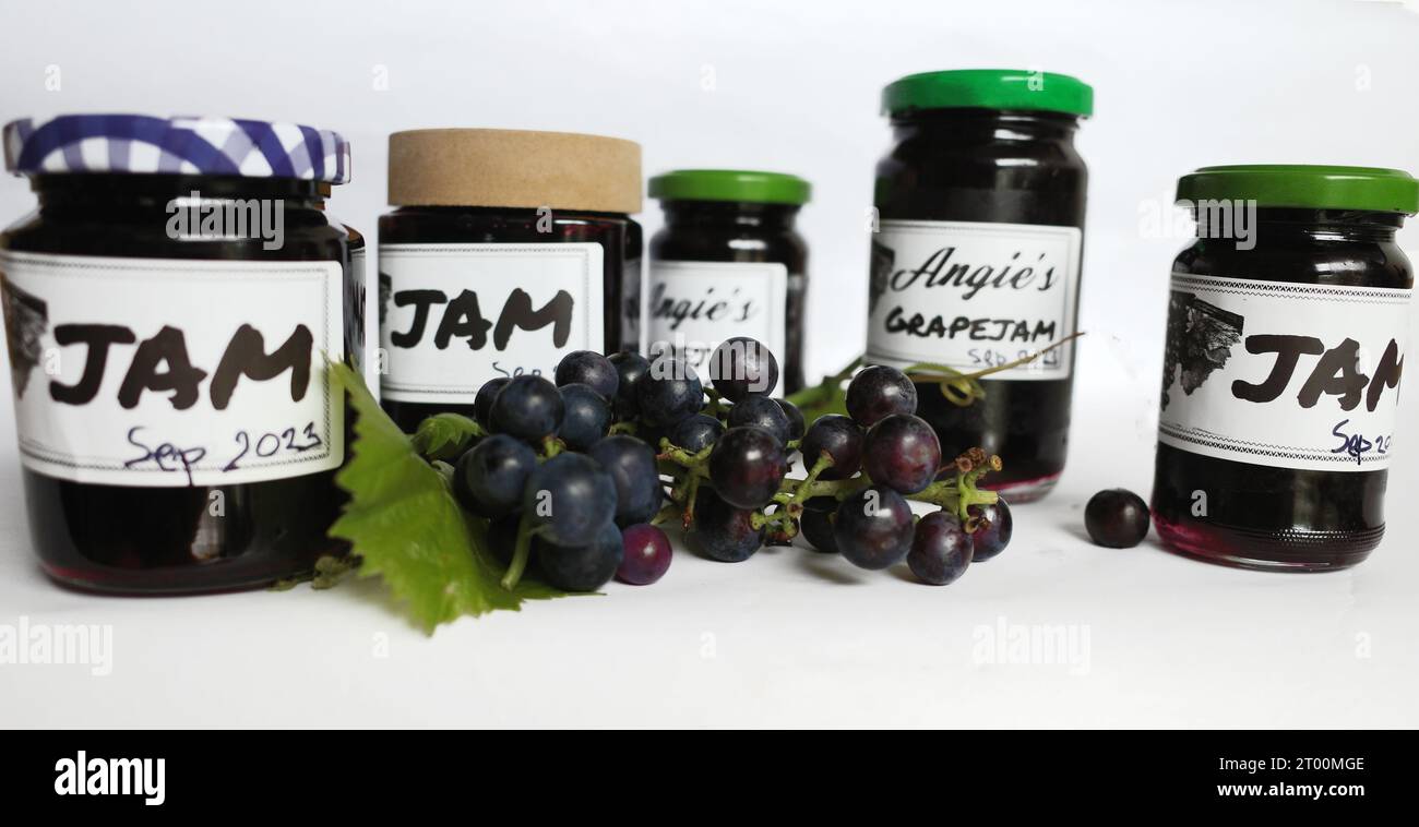 Homemade jam from dark red grapes out of the garden. Reuse of old glass ...