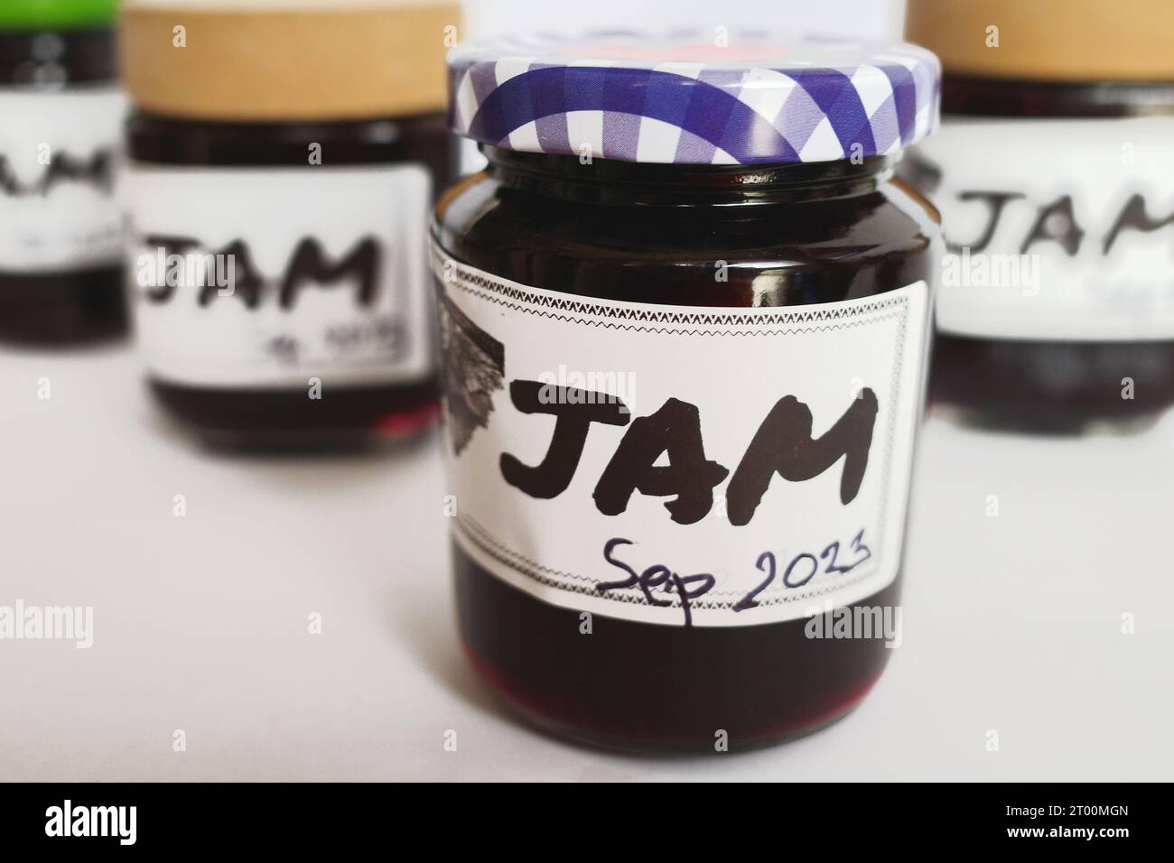 Homemade jam from dark red grapes out of the garden. Reuse of old glass ...