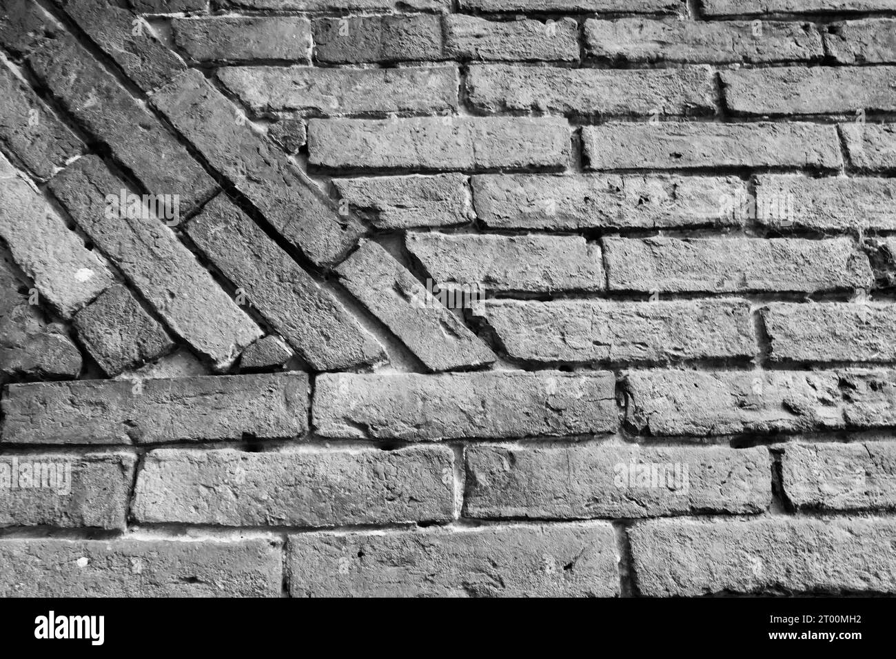 An old brick wall partly in black and white. Meant as background Stock ...