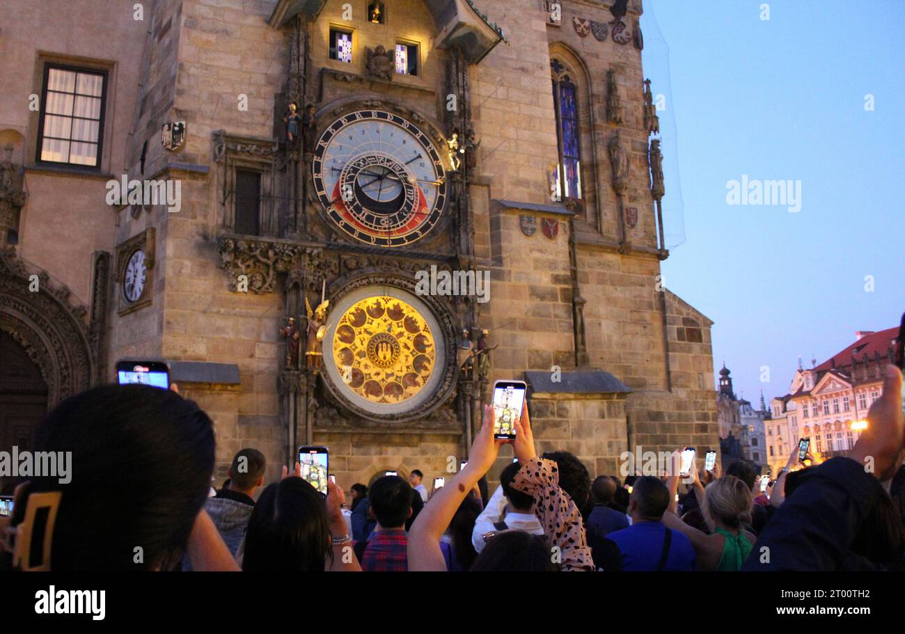 Tourists take photos of the historical astronomical clock at Prague's ...