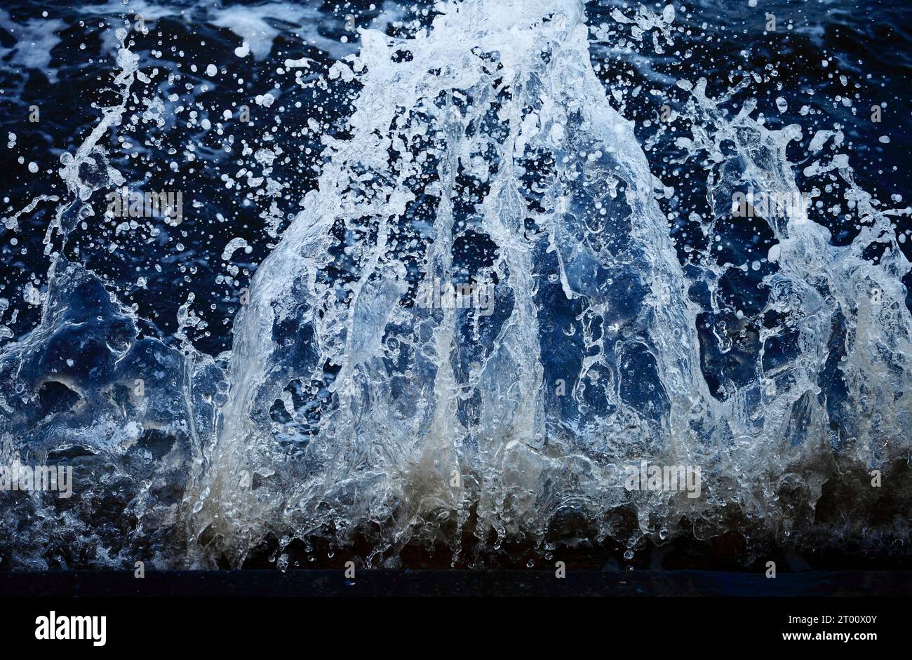 Sea water splashing against sea wall Stock Photo - Alamy