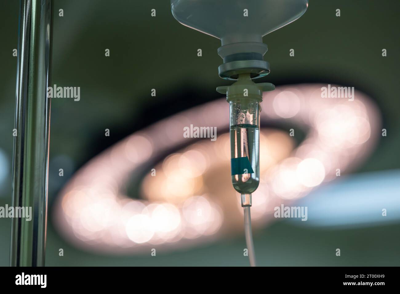 Intravenous fluid from the saline bag and operating room light ...