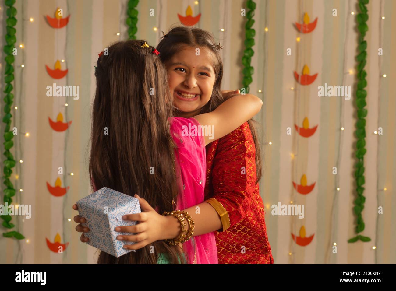 girls are happy and giving hug to eachother on the occasion of Diwali ...