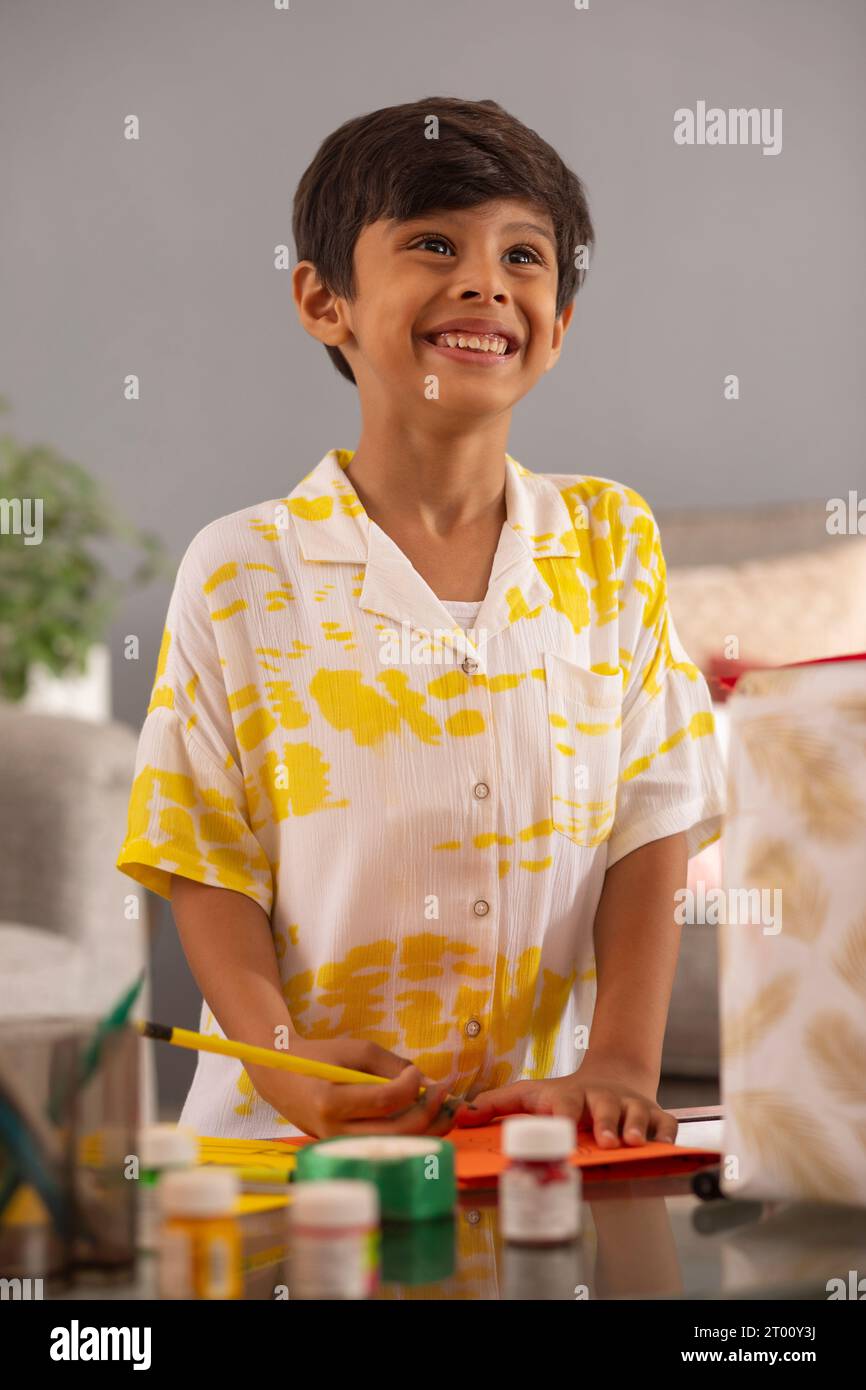 Portrait of a cheerful boy drawing at home Stock Photo - Alamy