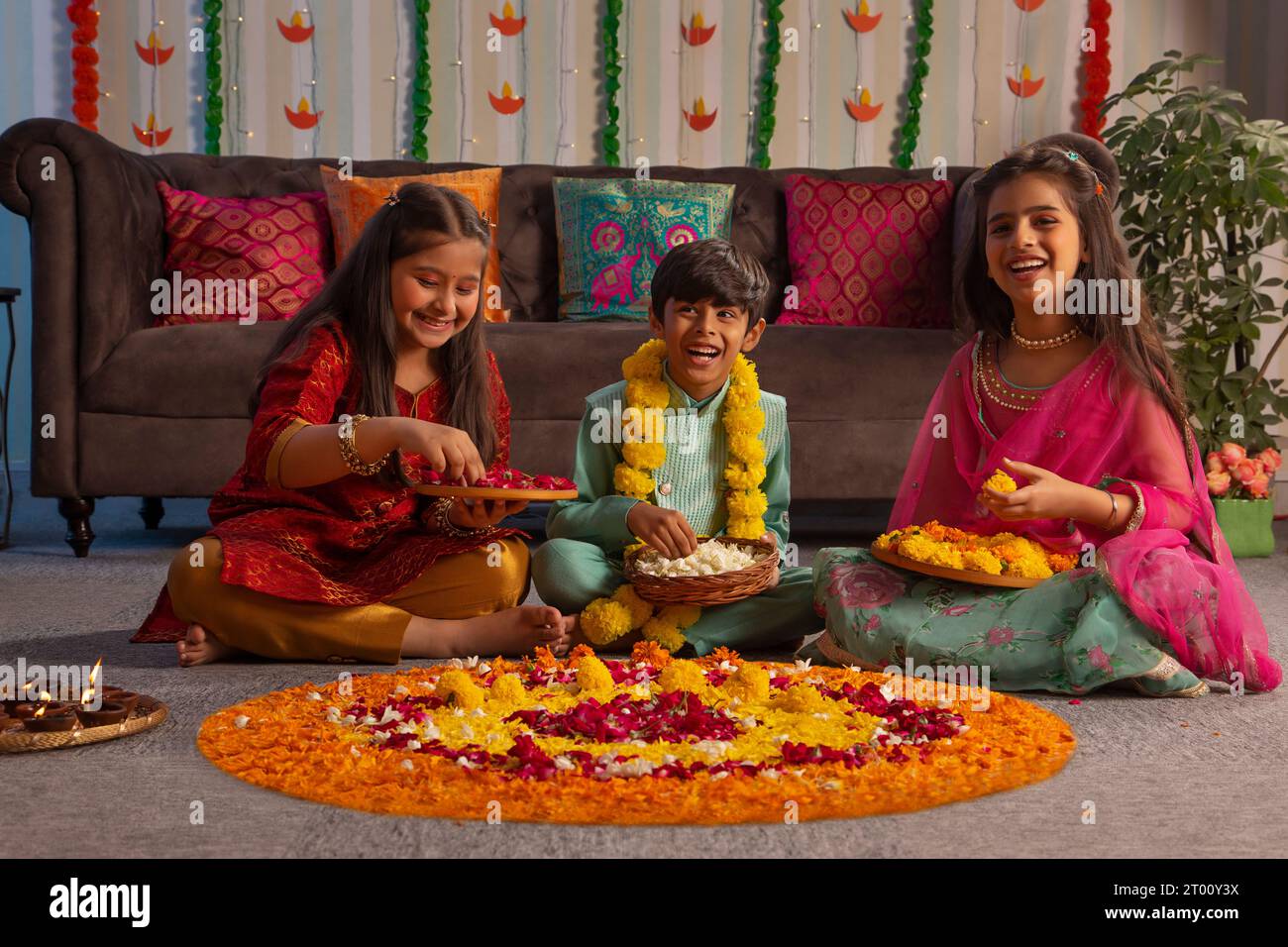 Children making floral rangoli together on the occasion of Diwali Stock ...