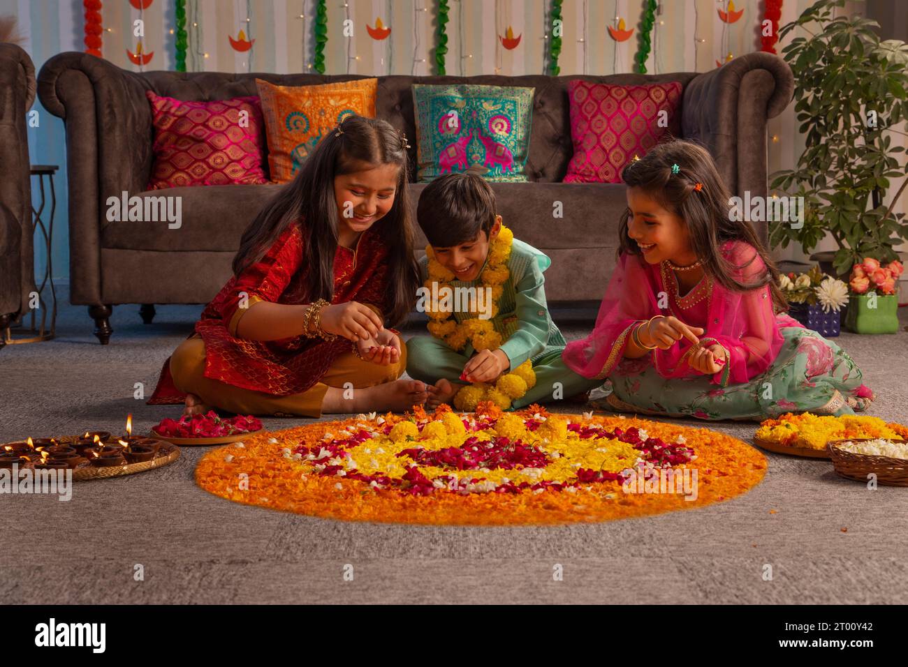 Children making floral rangoli together on the occasion of Diwali Stock ...