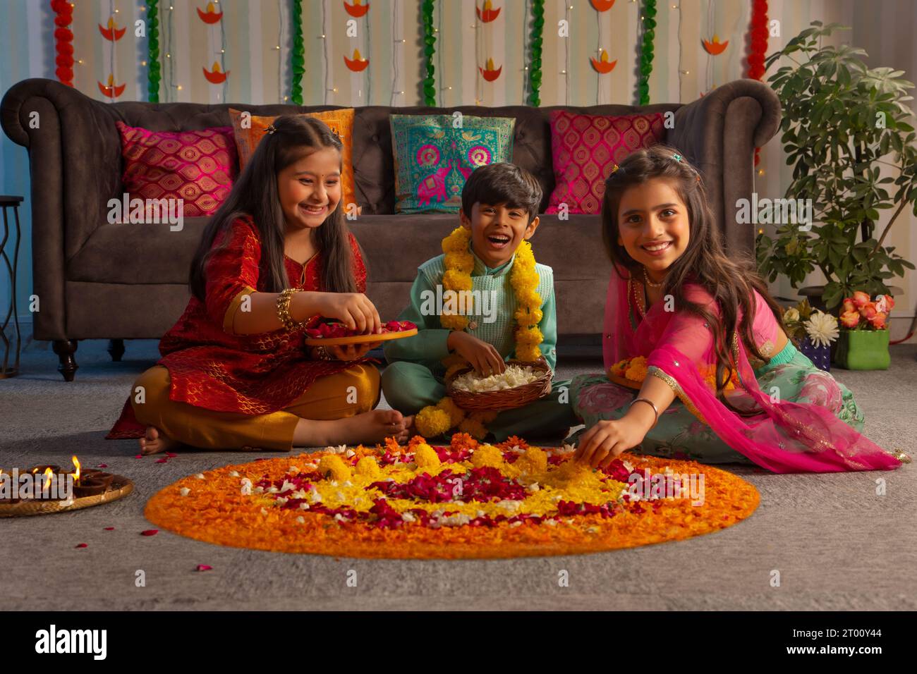 Children making floral rangoli together on the occasion of Diwali Stock ...