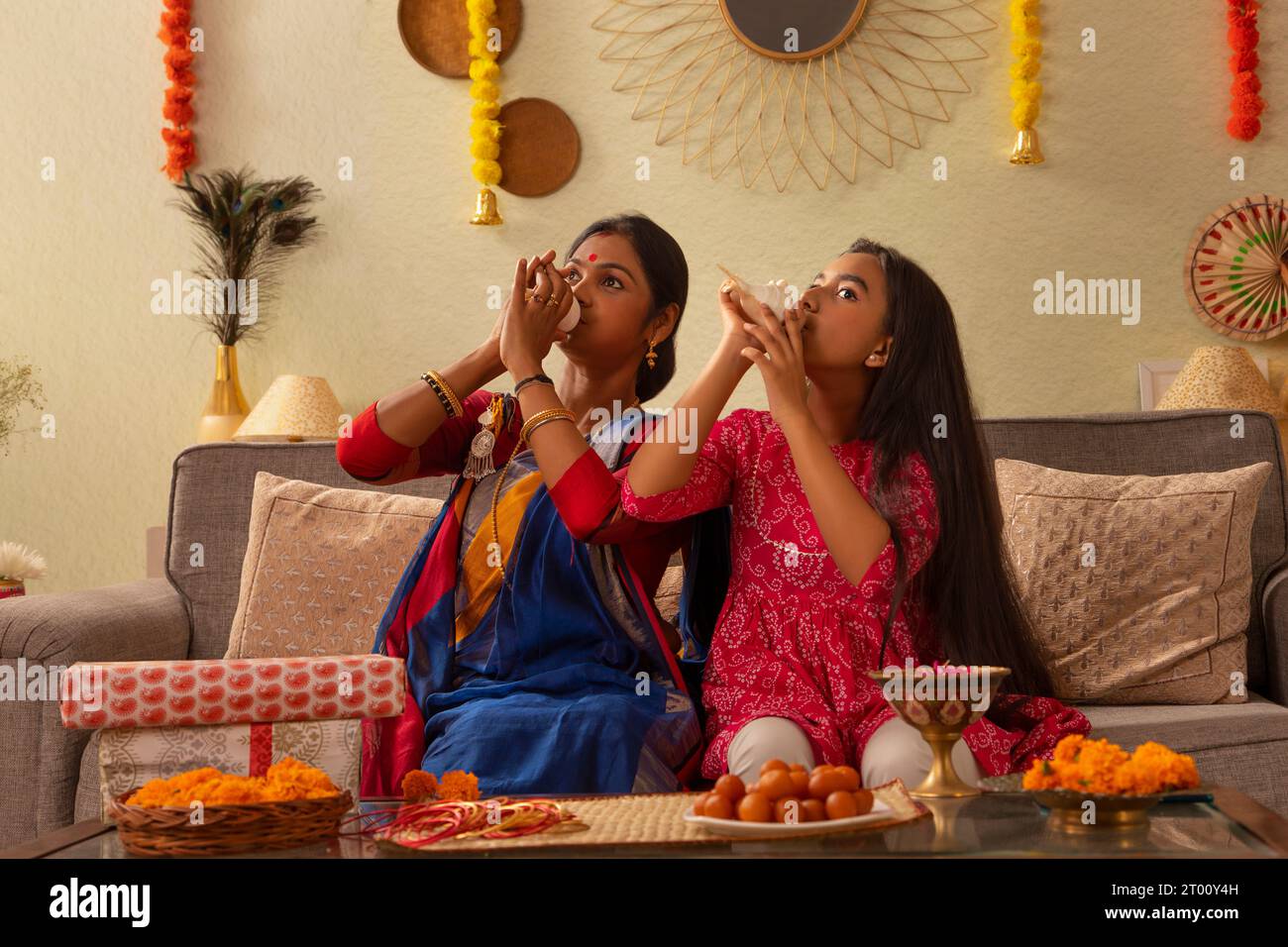 Mother and daughter together playing conch Stock Photo - Alamy