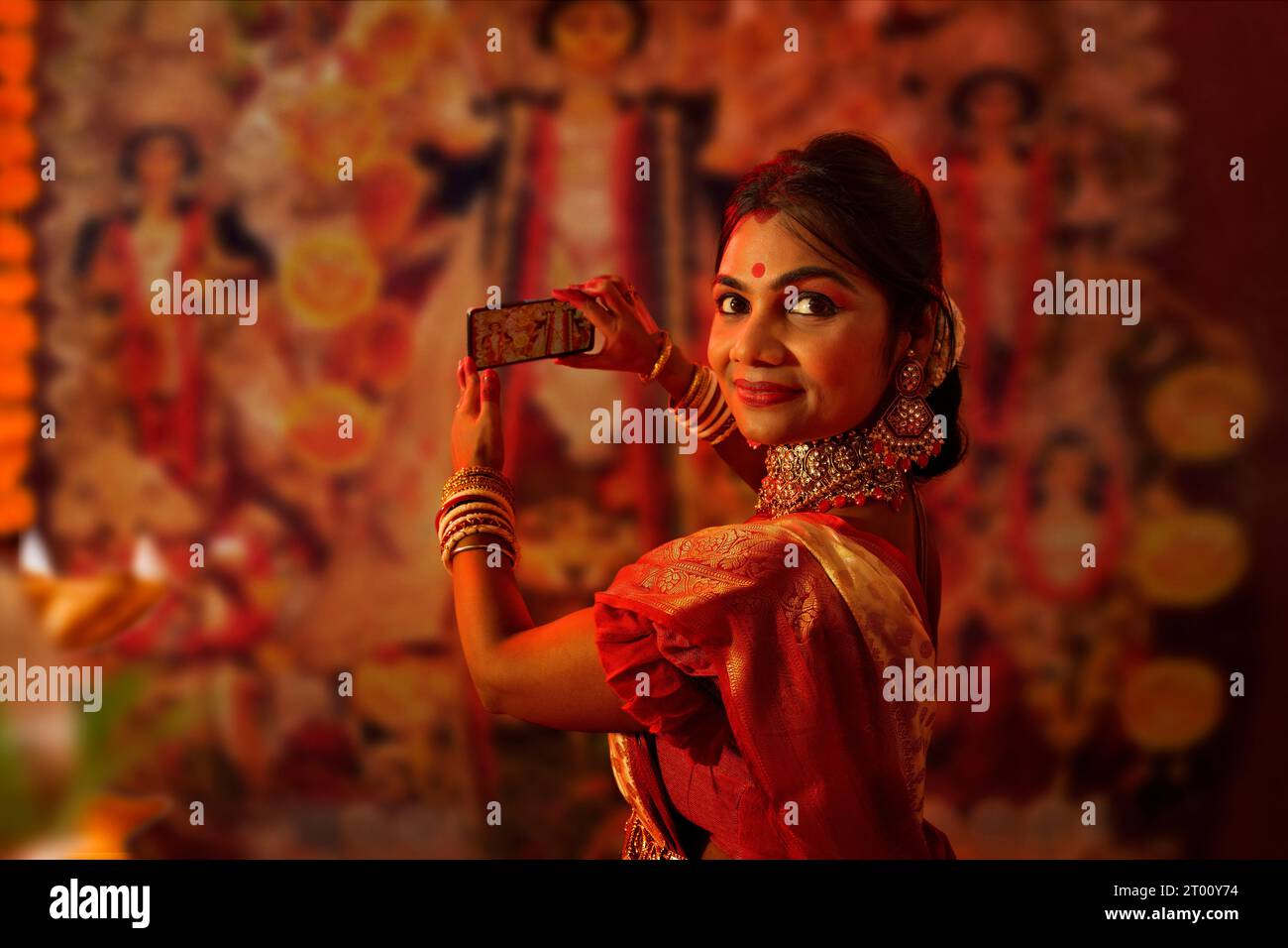 Bengali woman capturing photographs of Devi Durga Stock Photo - Alamy