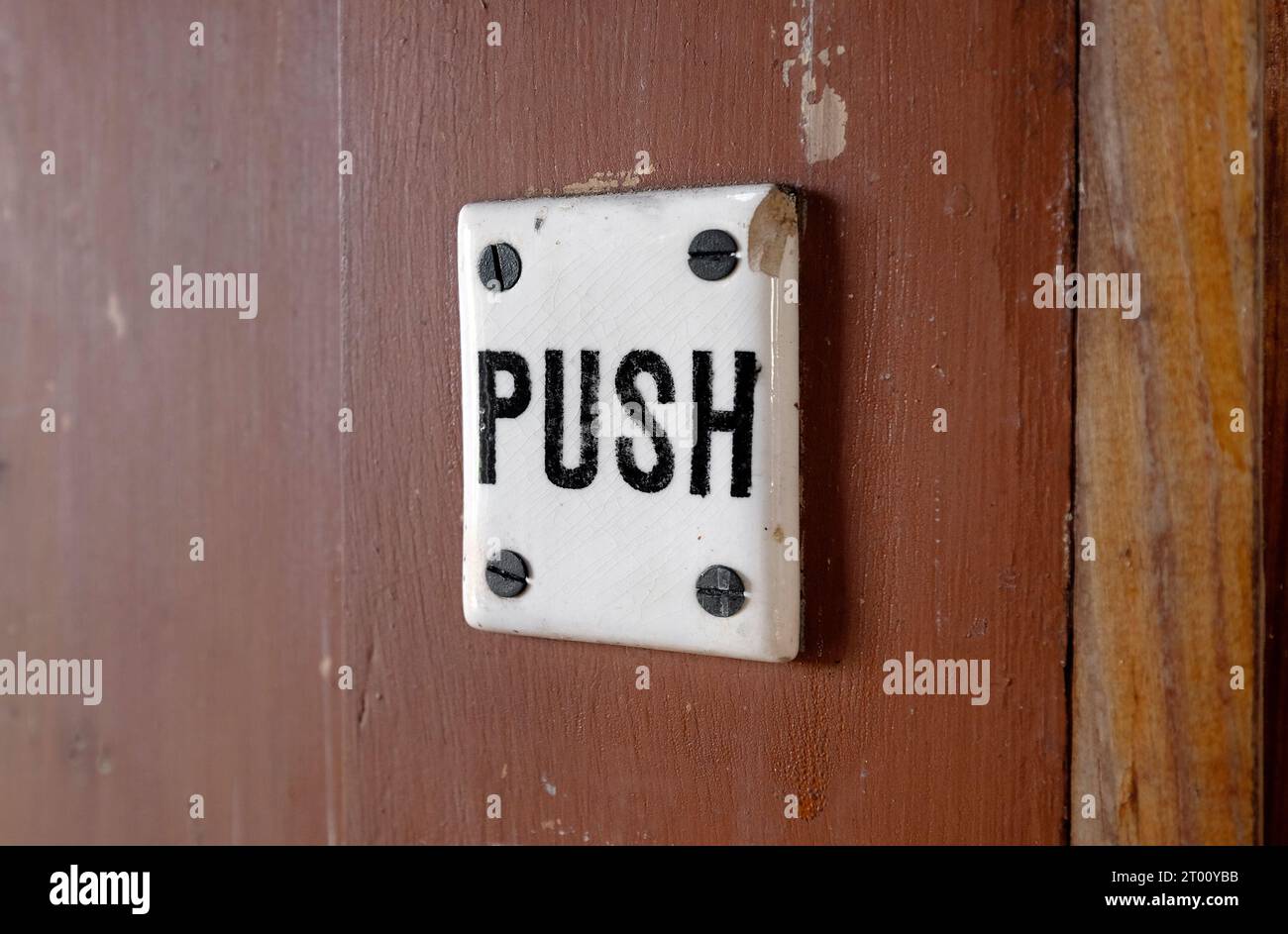 old porcelain push sign on brown door Stock Photo - Alamy