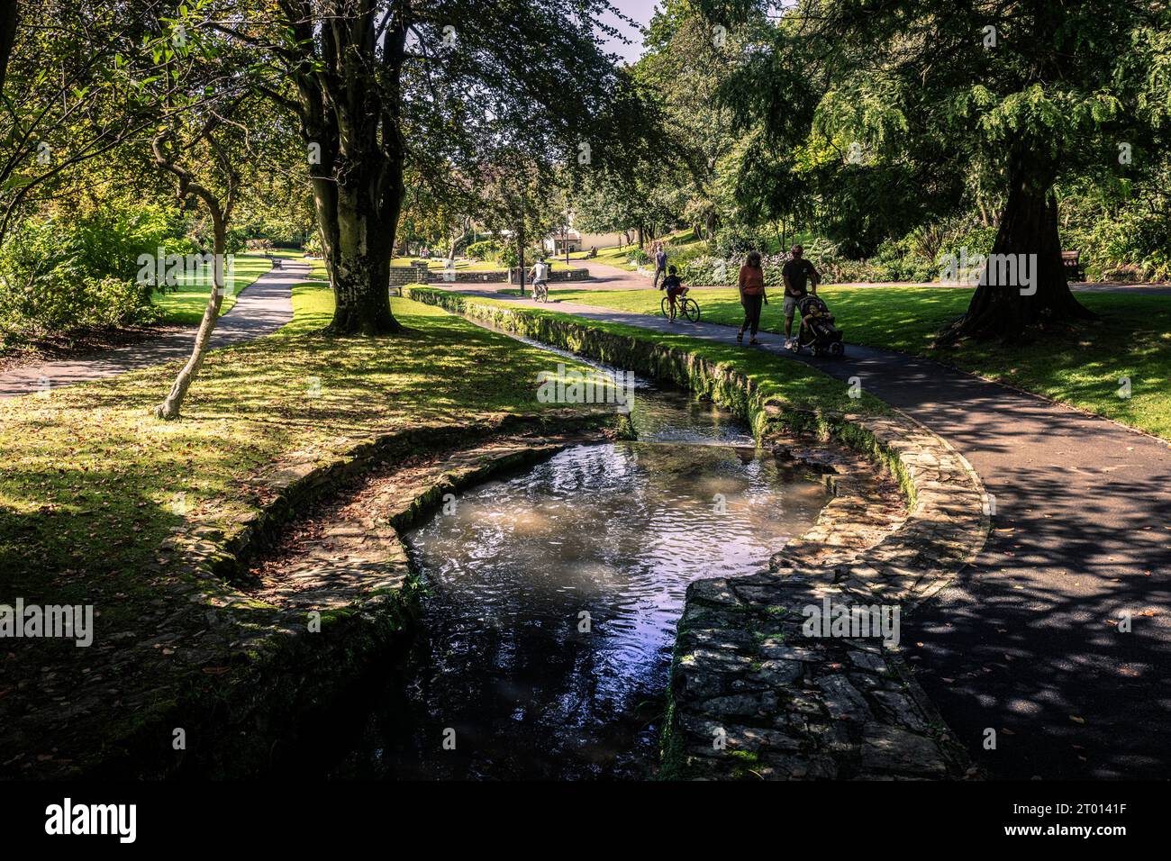 A small river stream flowing through the landscaped Trenance Gardens in ...