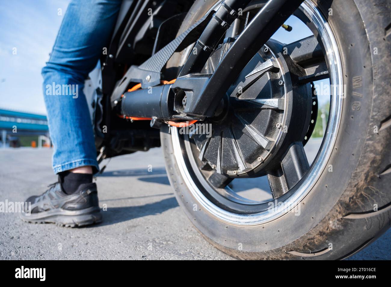 Close-up of the rear wheel with the engine of an electric motorcycle ...