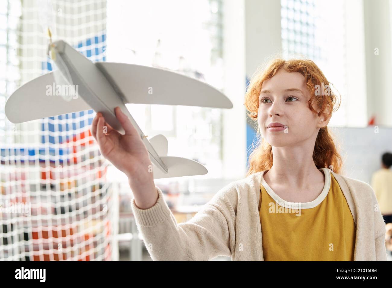 Inspired girl playing with plane model, dreaming to become pilot in ...