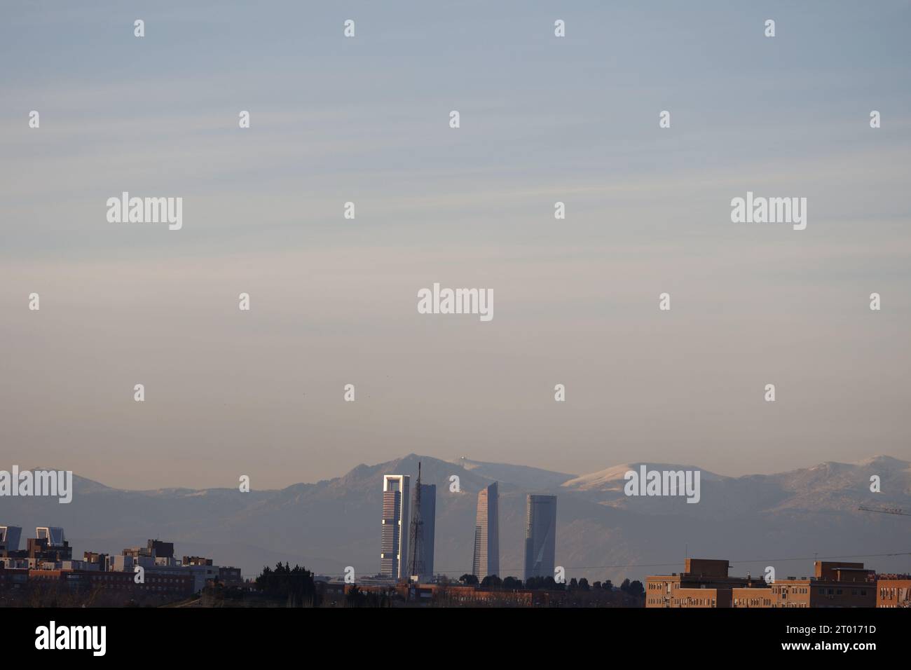 Five towers of Madrid, overlooking a distant mountain backdrop against ...