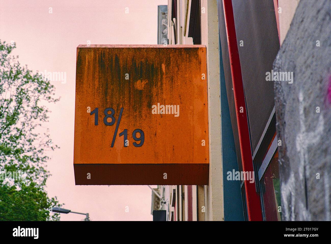 Old and worn out house number sign, mounted on the facade of a down ...