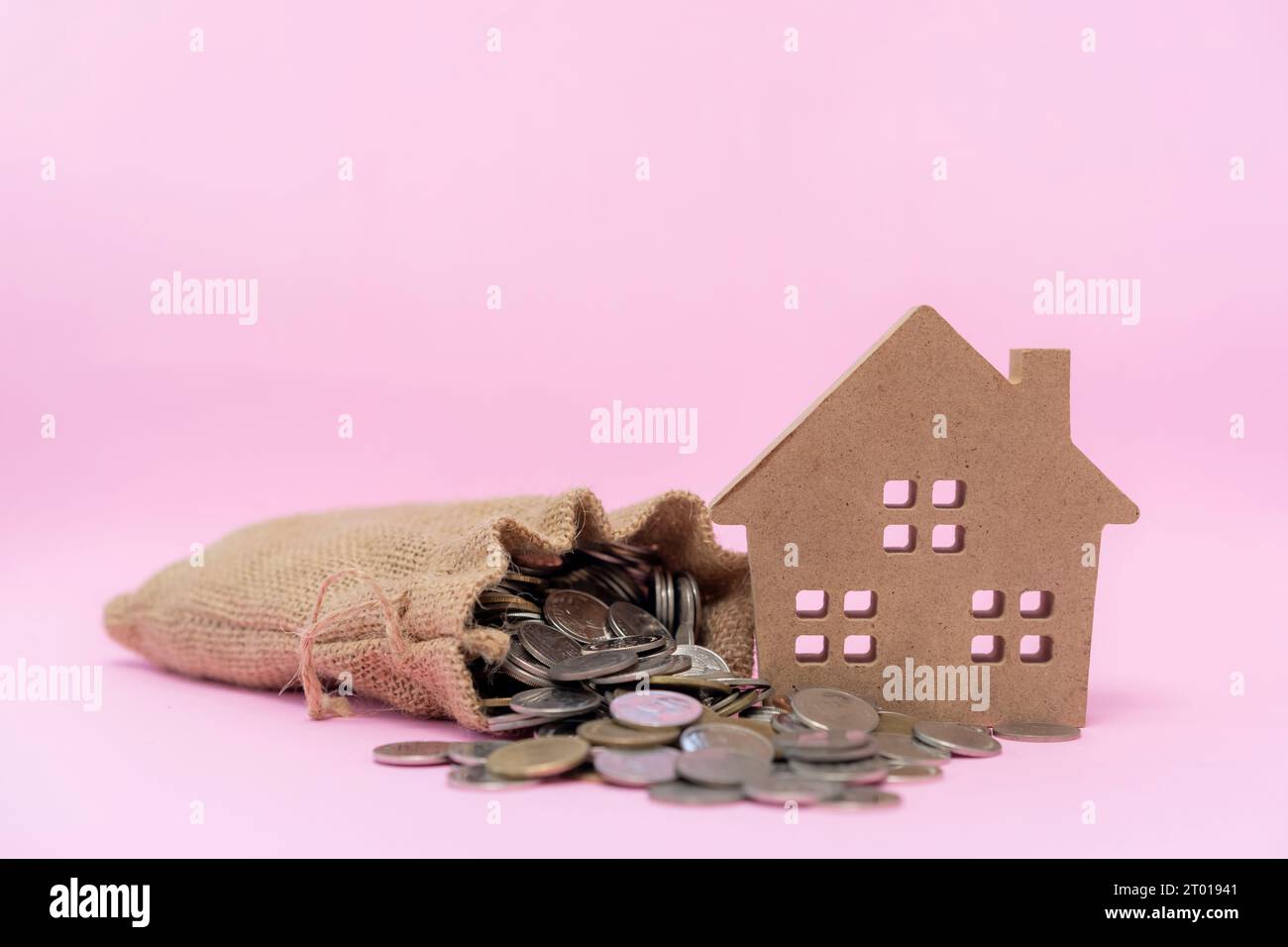 Money stack with home on pastel pink background Stock Photo - Alamy