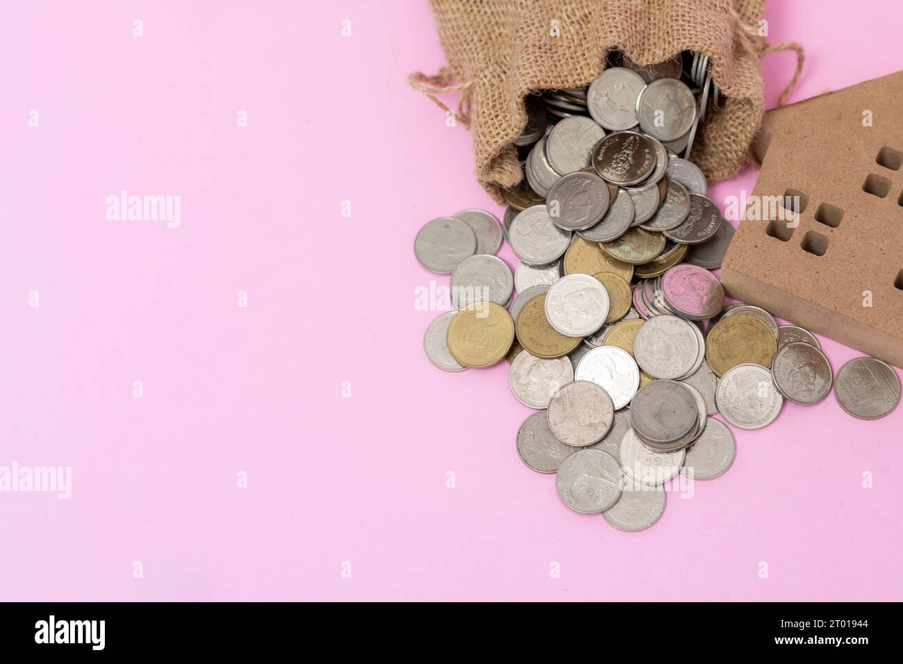 Money stack with home on pastel pink background Stock Photo - Alamy
