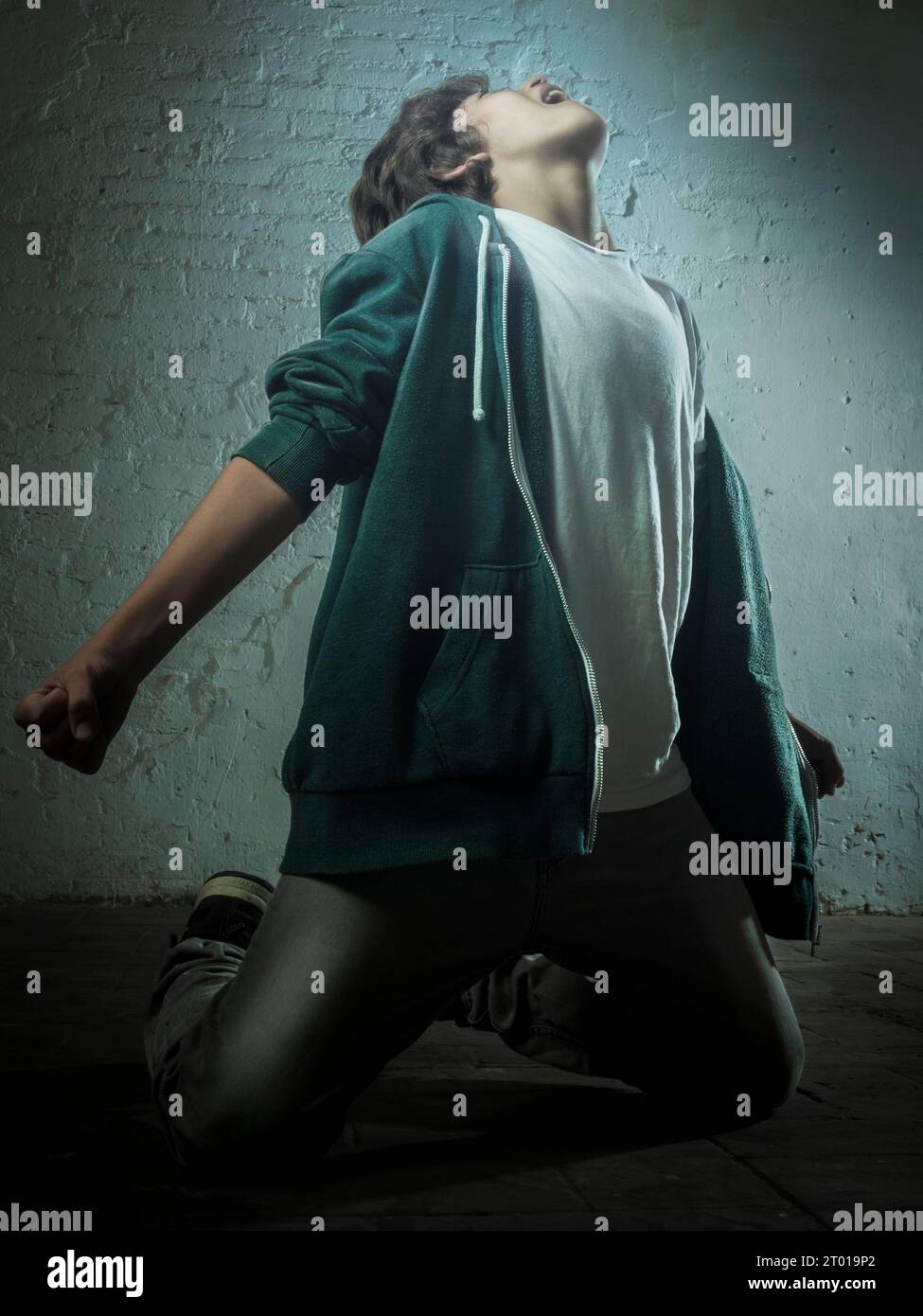 Human kneeling in pain hi-res stock photography and images - Alamy