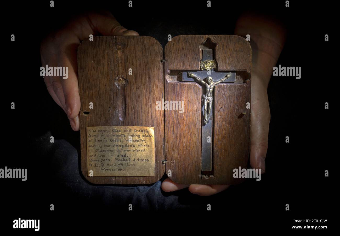 Special collections manager Dr. Hannah Thomas holds a crucifix, the ...