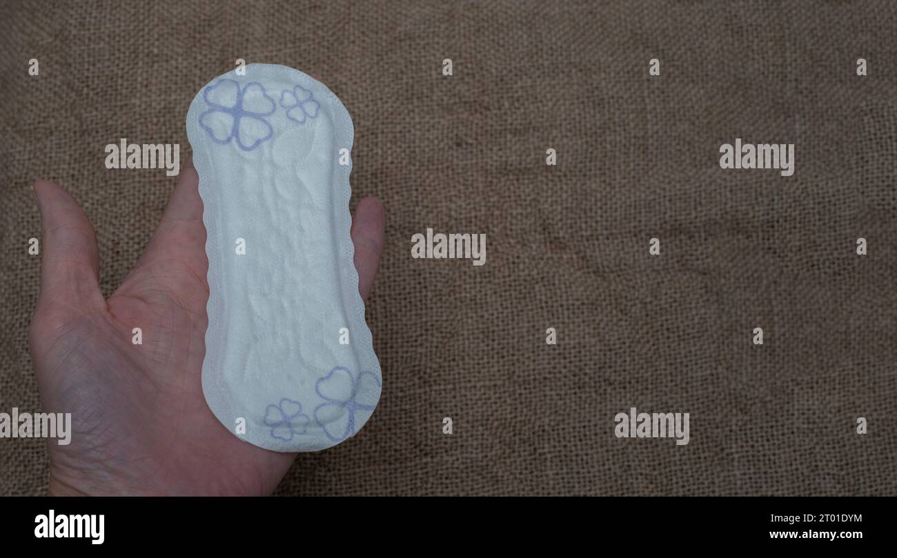 Ladies hygienic daily pads on brown background.woman hand holding daily ...