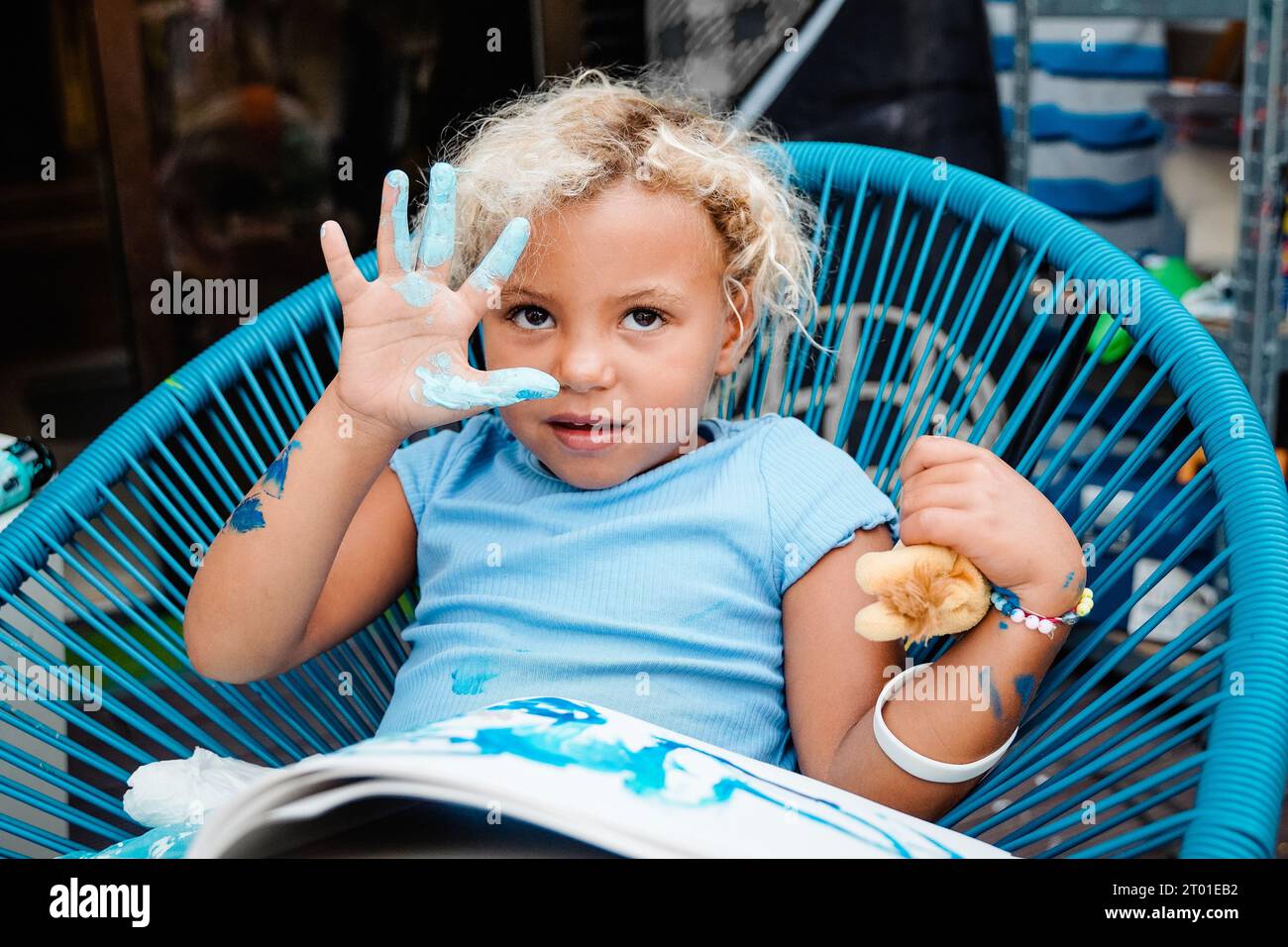 Mixed Race kid girl painting with acrylic colors and having fun ...