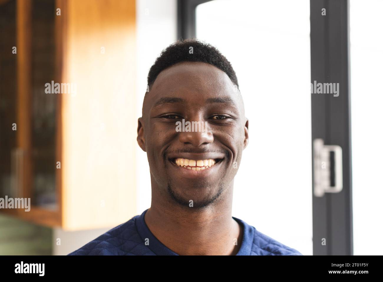 Portrait of happy african american man with short black hair smiling at ...