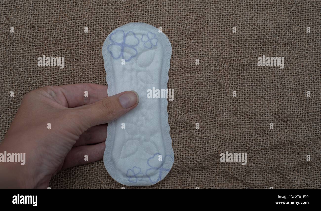 Ladies hygienic daily pads on brown background.woman hand holding daily ...