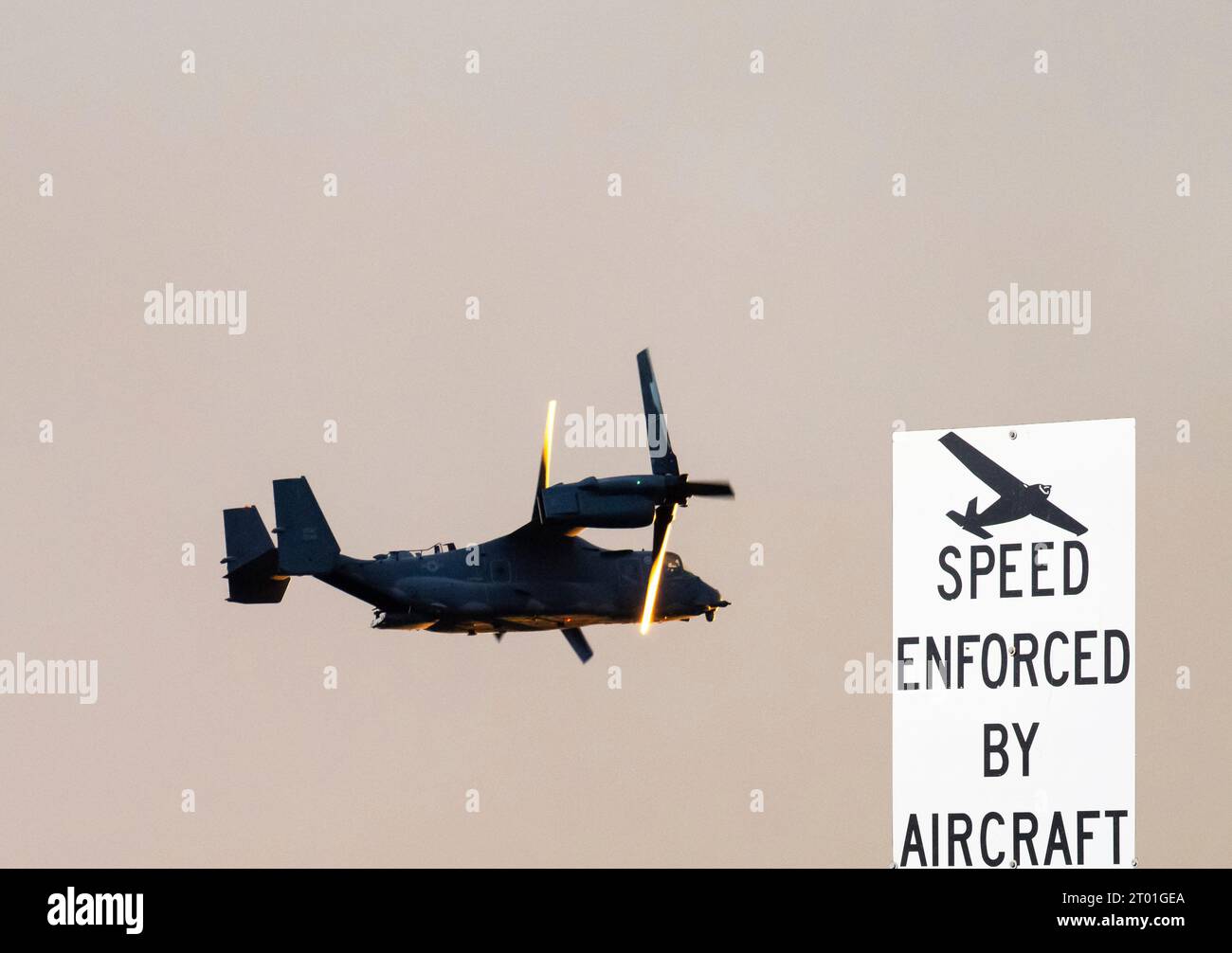 An Osprey, a vertical take off and landing airplane flying at sunset ...