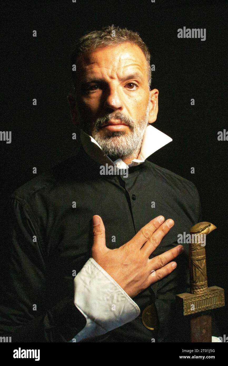 Man dressed in black and white collar with serious gesture that looks ...