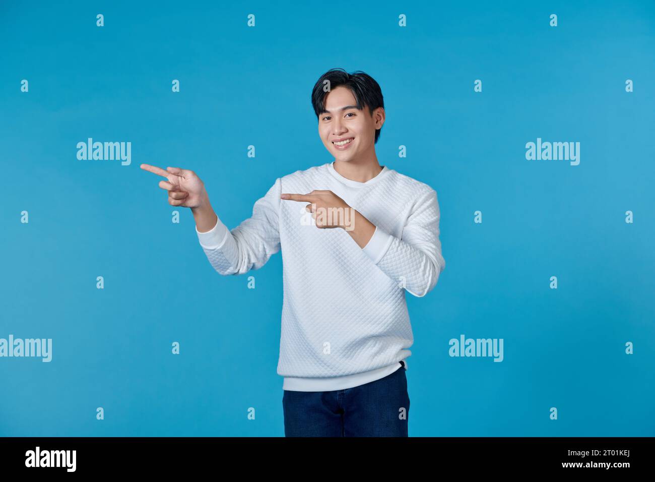 The young man standing on his side pointed his hand to the side with a ...