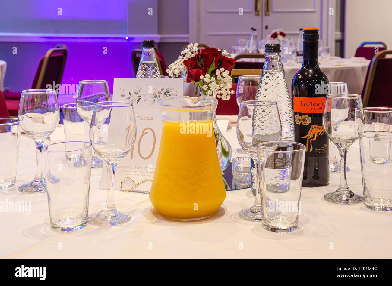 Drinks and glasses in the centre of a table for a party in a hotel ...