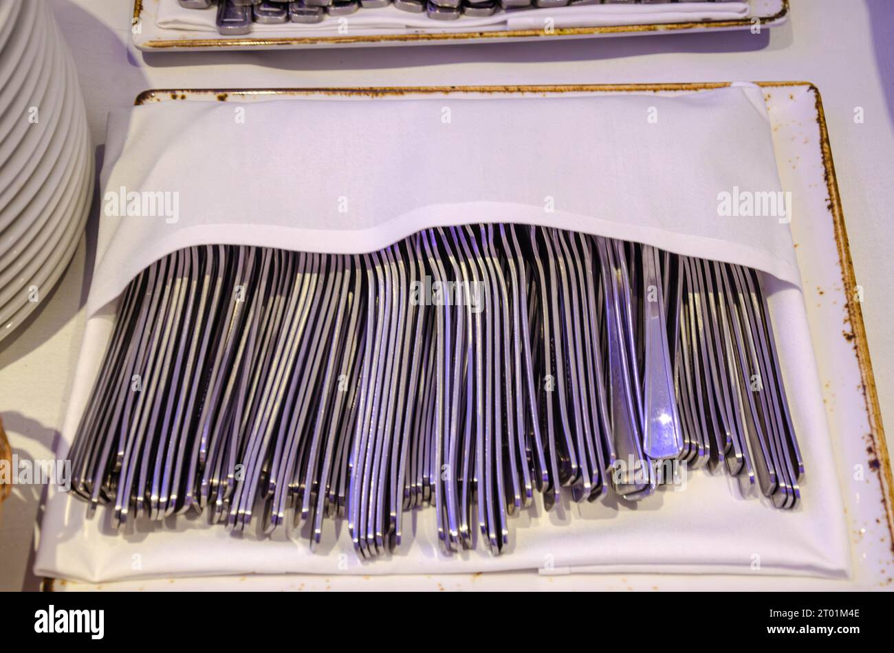 Table forks laid out on a table at a self service, help yourself buffet ...