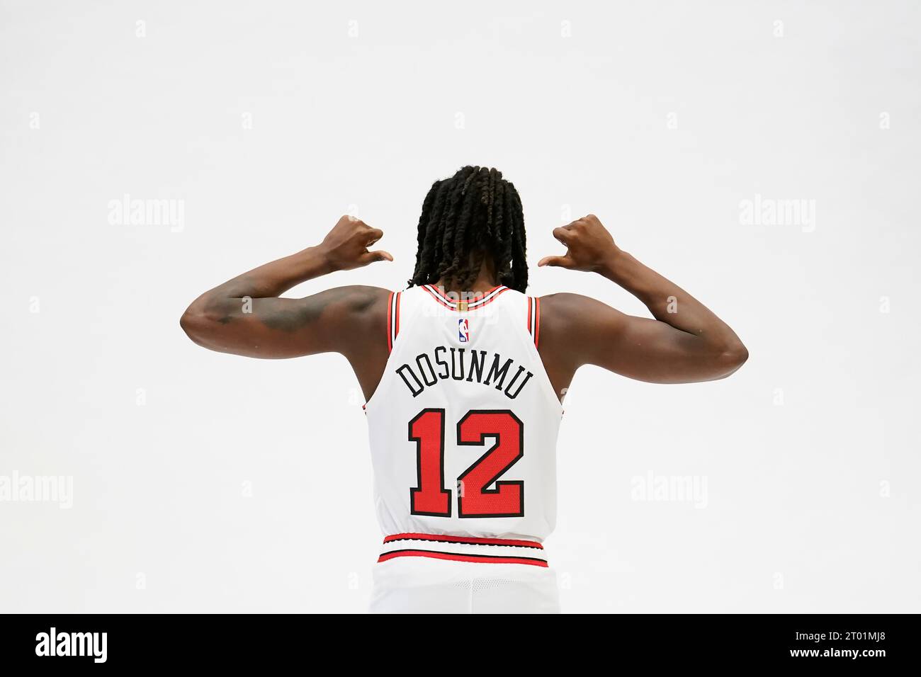 Chicago Bulls guard Ayo Dosunmu points to his name on the back of his ...