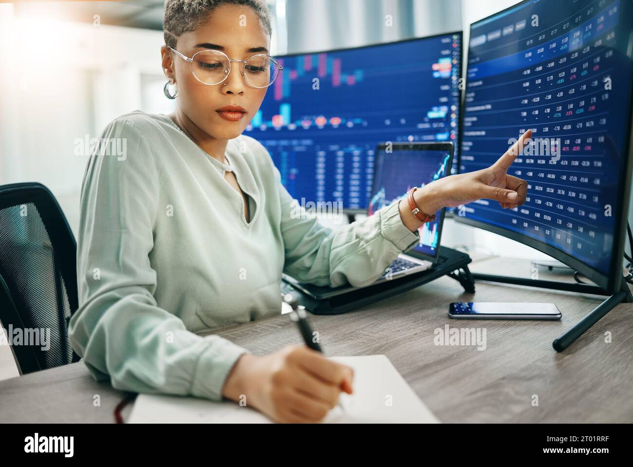 Woman, computer screen and trading, writing notes from dashboard and ...