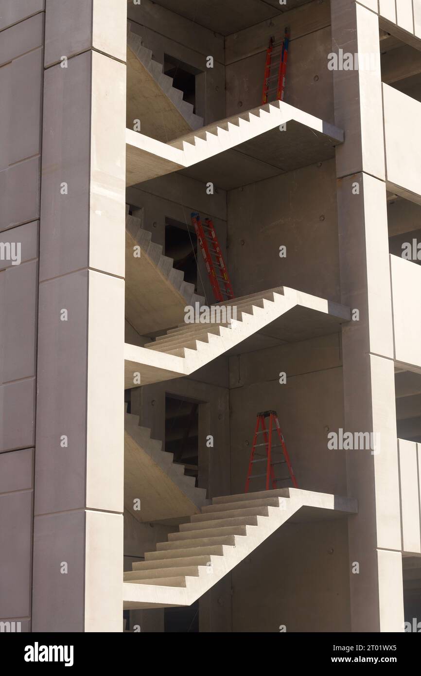 A vertical shot of a cement staircase with ladders in a newly ...