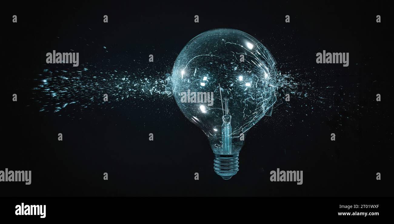 large filament bulb shatters on black background Stock Photo - Alamy