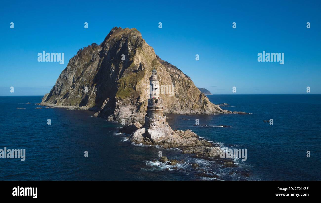 An old, abandoned Japanese lighthouse stands silently at the edge of ...