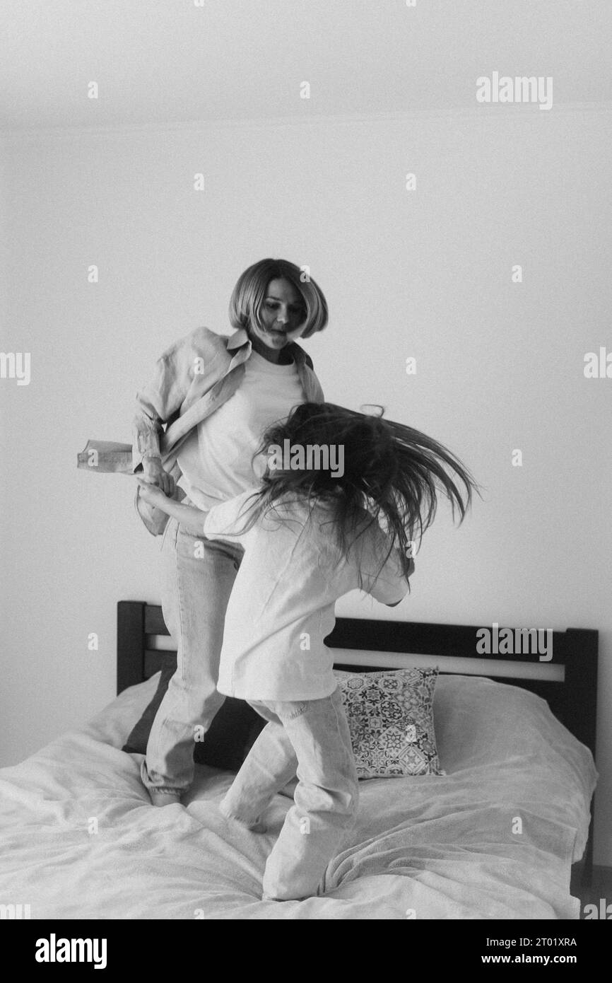 Jumping onto bed Black and White Stock Photos & Images - Alamy