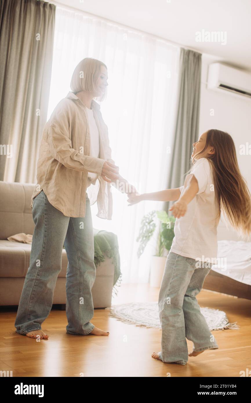 Mom and her daughter child girl are dancing. Family holiday and ...
