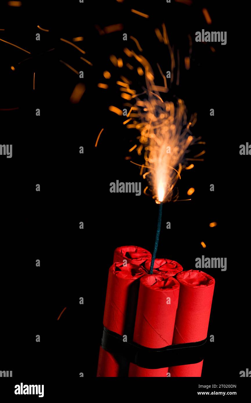 Sticks of Dynamite with lit fuse, sparks a flying, agaisnt a black ...