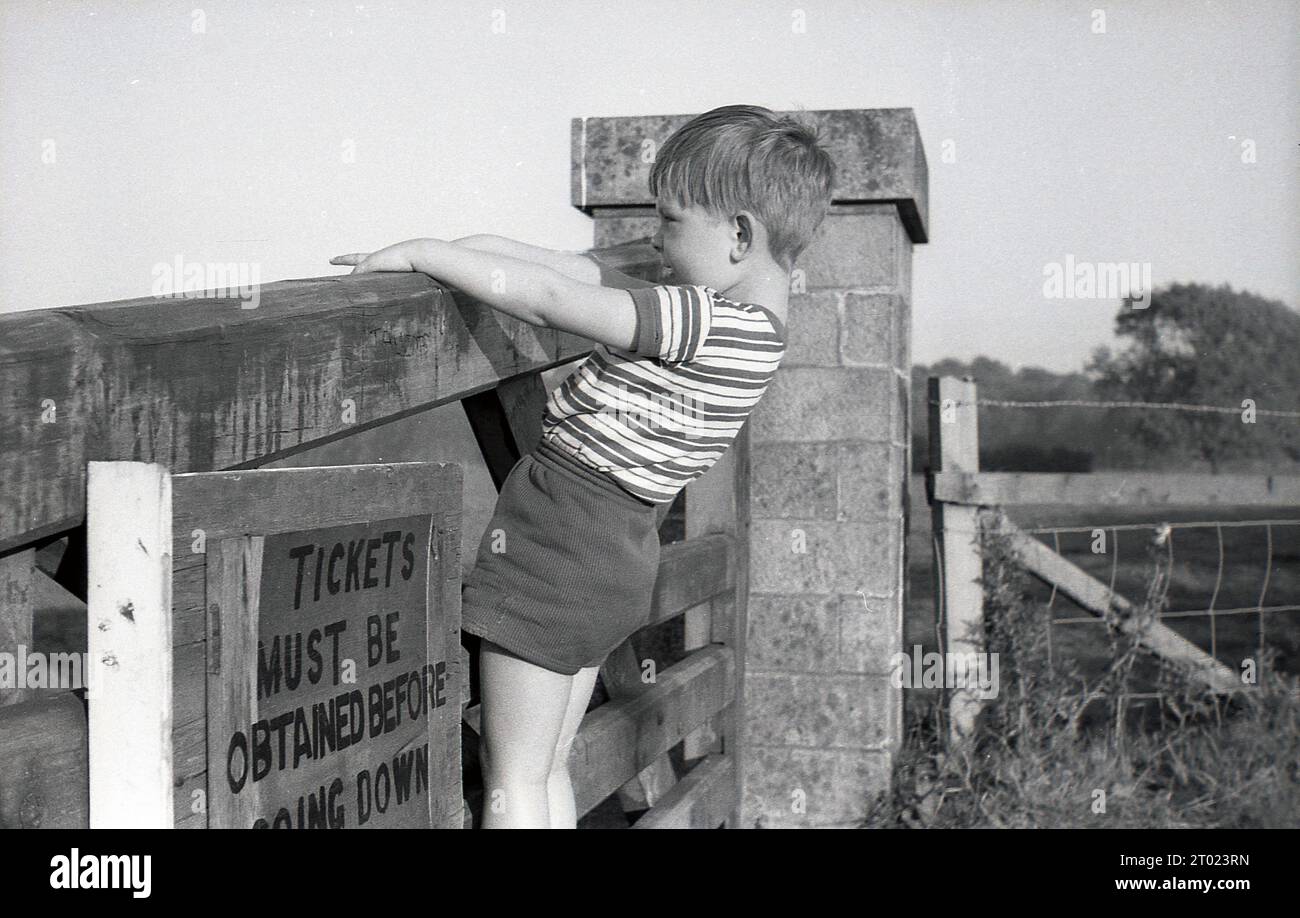1960s, historical, out in the countryside, a young boy standing on the ...