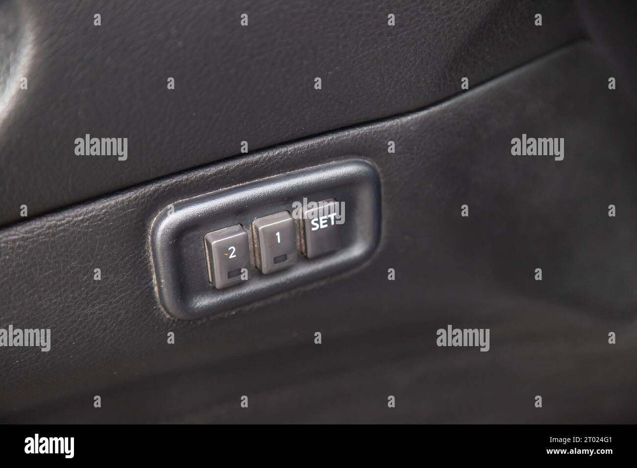 Automatic seat memory buttons with white signs and symbols are located ...