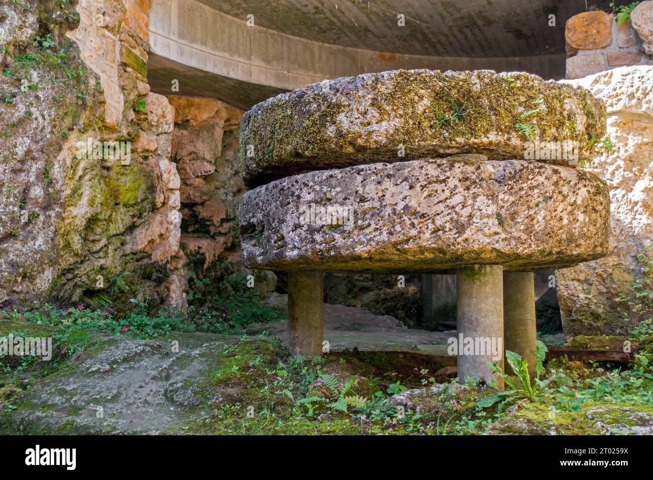 Old millstones in the Trou des Fées at the village Chassepierre near ...