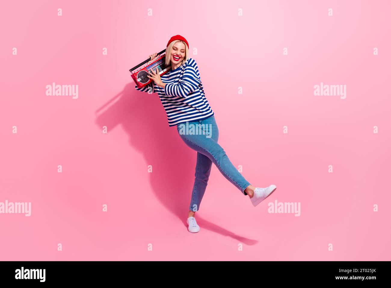 Full length photo of cheerful pretty lady wear striped shirt listening ...