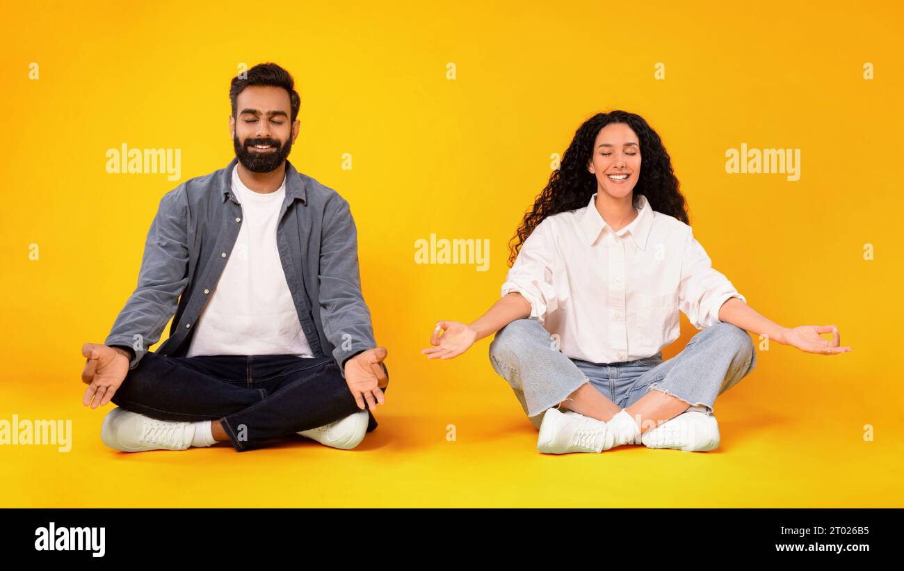 Arabic Couple Meditating Sitting In Lotus Pose Over Yellow Background ...
