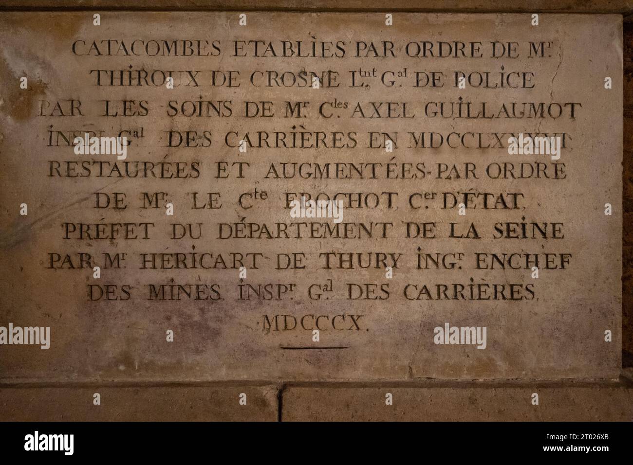 In the Paris Catacombs, a long underground path with structures formed ...