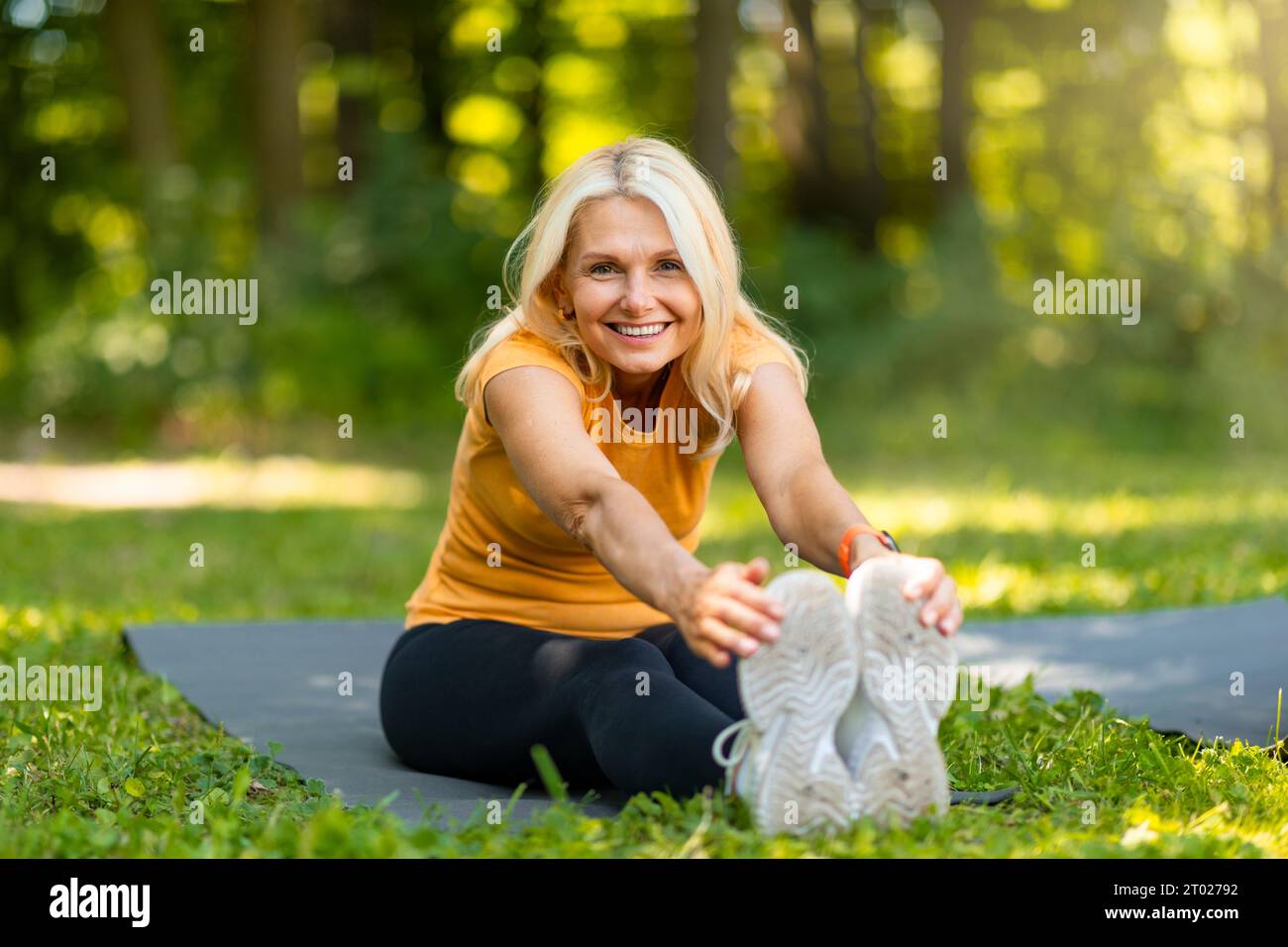 Outdoor Fitness. Portrait Of Beautiful Senior Woman Stretching Leg ...