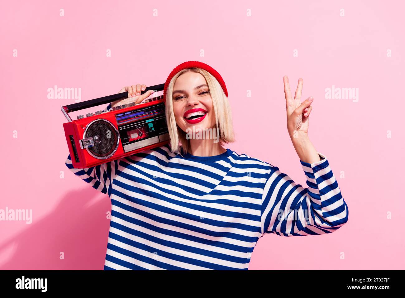 Photo of pretty cheerful lady wear striped shirt listening boom box ...