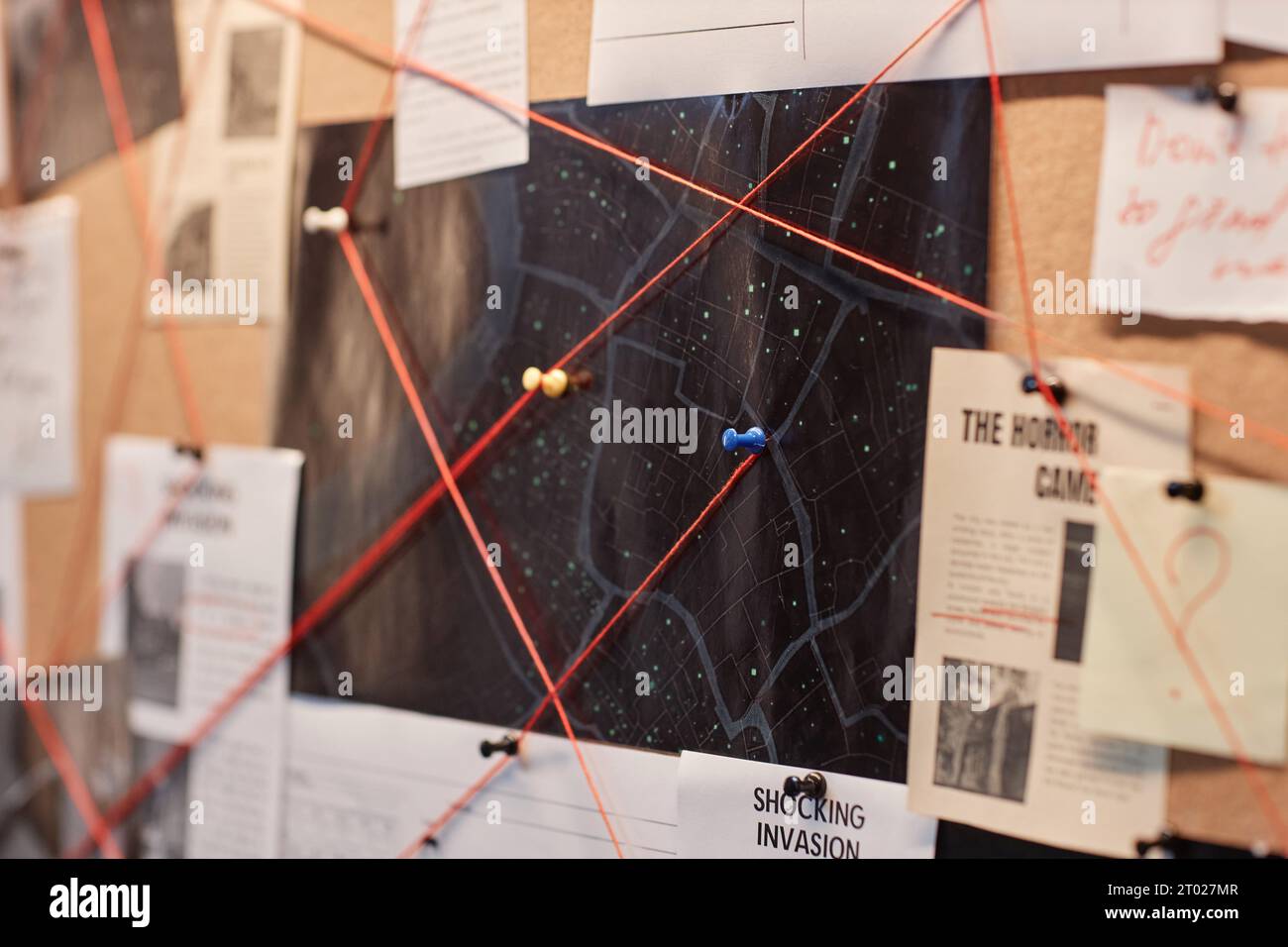 Closeup background image of evidence board with red thread connecting ...
